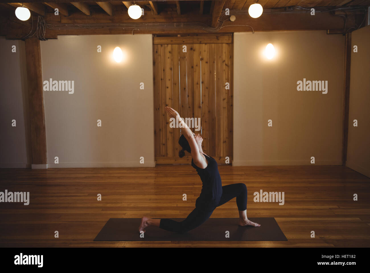 Woman practising yoga in fitness studio Stock Photo - Alamy
