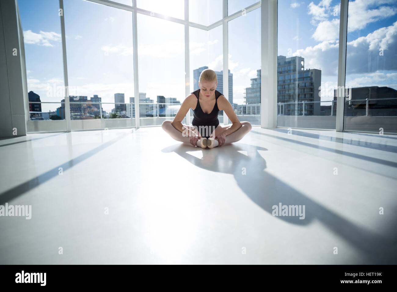 Ballerina performing a stretching exercise in the ballet studio Stock ...