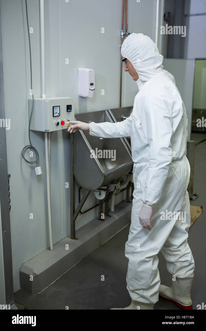 Technician operating machine at meat factory Stock Photo - Alamy
