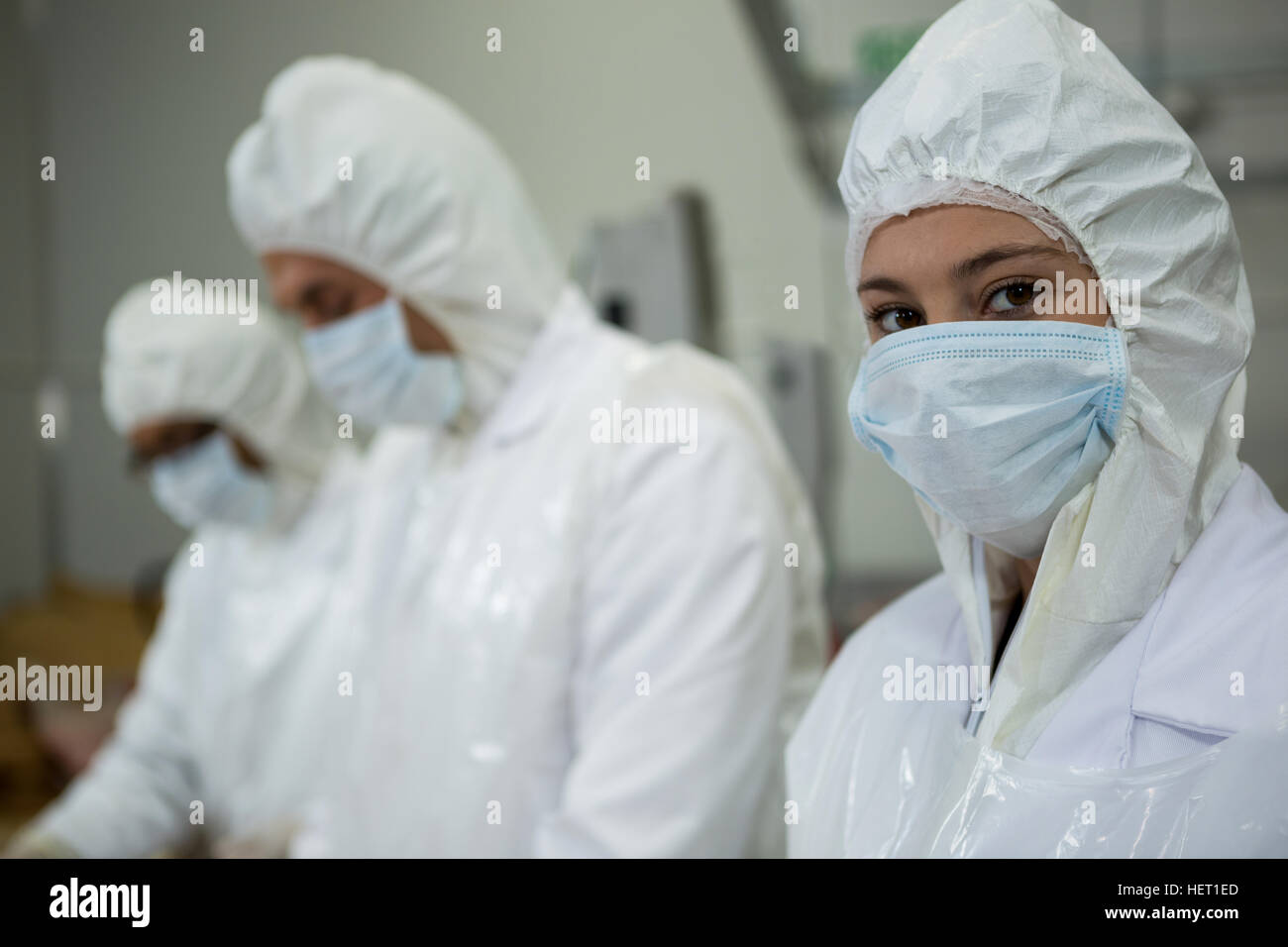Close-up of butchers wearing mask at meat factory Stock Photo - Alamy
