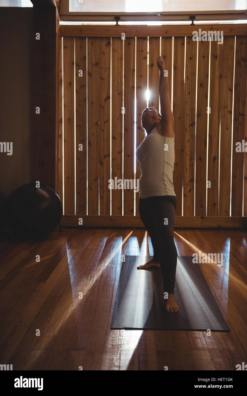 Woman practising yoga in fitness studio Stock Photo - Alamy