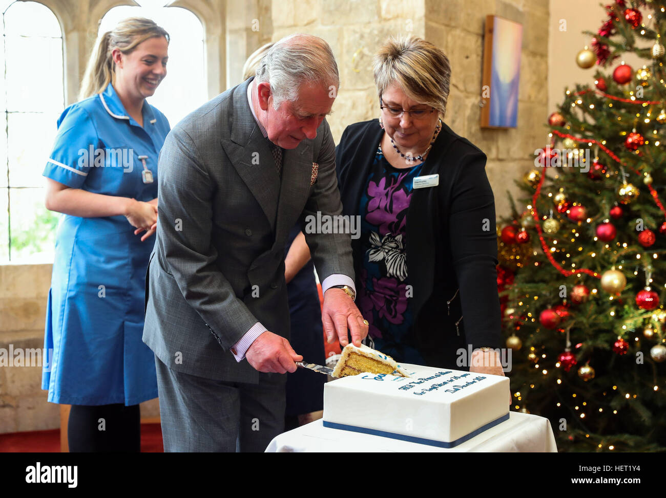 The Prince of Wales cuts a commemorative cake during a visit to the Sue ...