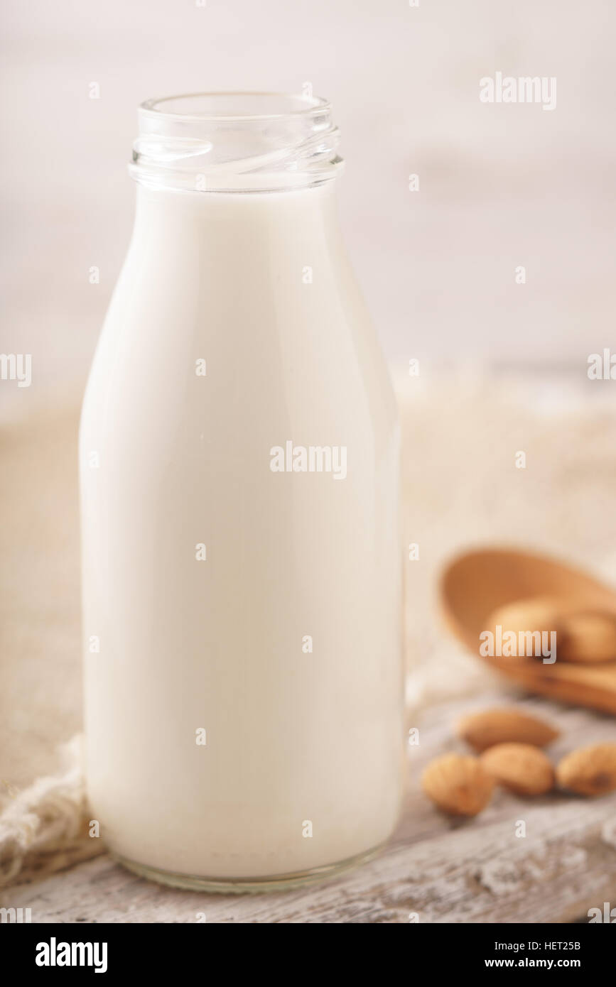 Almond milk in a glass bottle vertical Stock Photo - Alamy