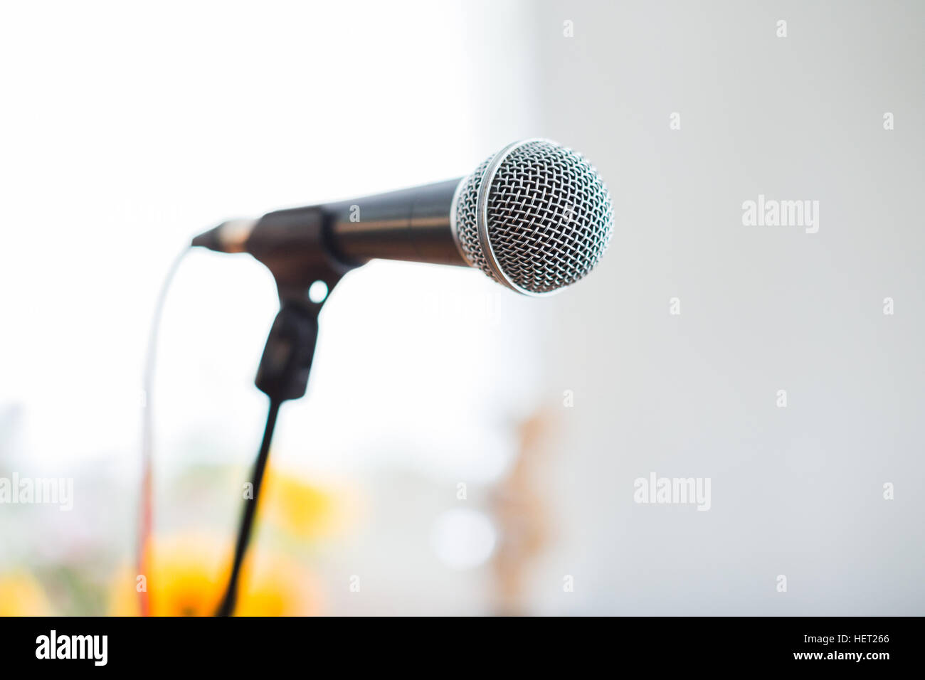 Vocal Microphone in focus against blurred audience at the conference or ...