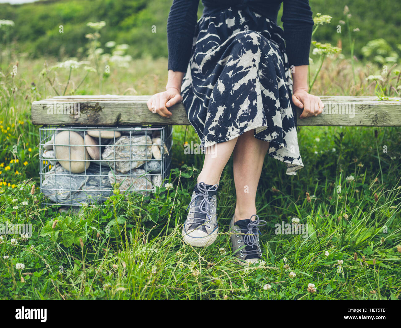 The legs and feet of a young woman sitting and relaxing in nature Stock ...