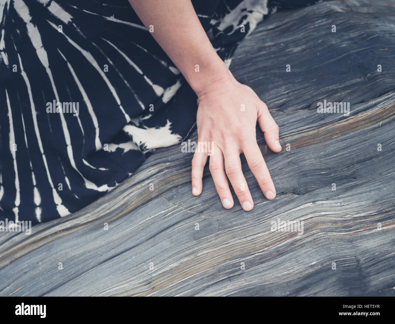 The hand of a young woman is touching a beautioful rock surface Stock ...