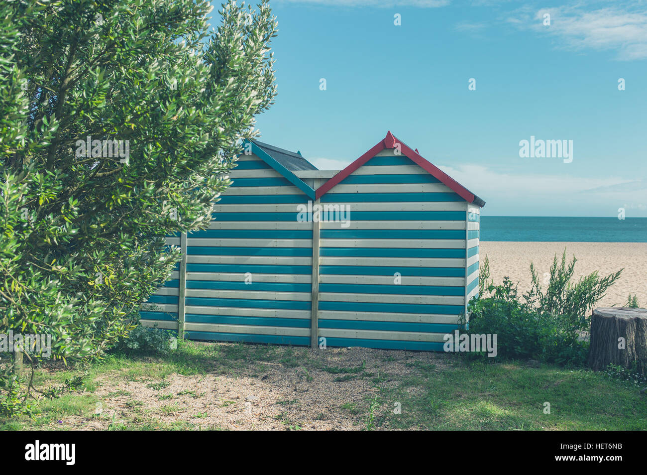 A couple of blue beach huts on the beach in the summer Stock Photo - Alamy