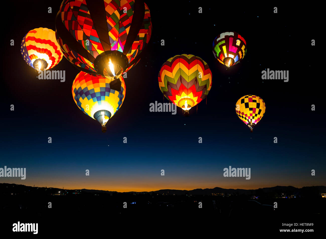 Colorful hot air balloons at dawn lit up in the sky Stock Photo - Alamy