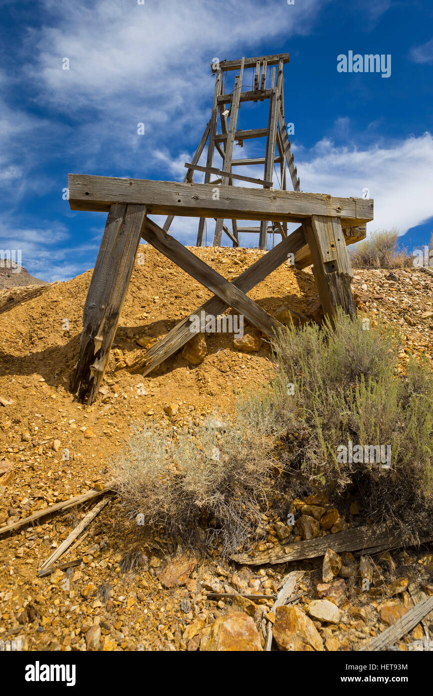 Old mining head frame in the Nevada Desert under blue sky with clouds ...