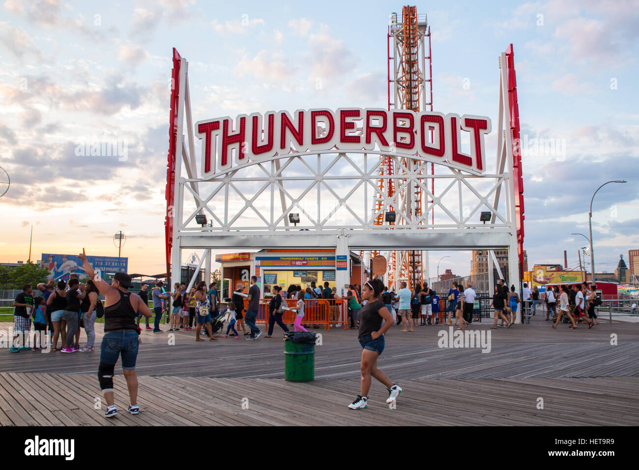 View of Coney Island Boardwalk with rides and people visible. Brooklyn ...