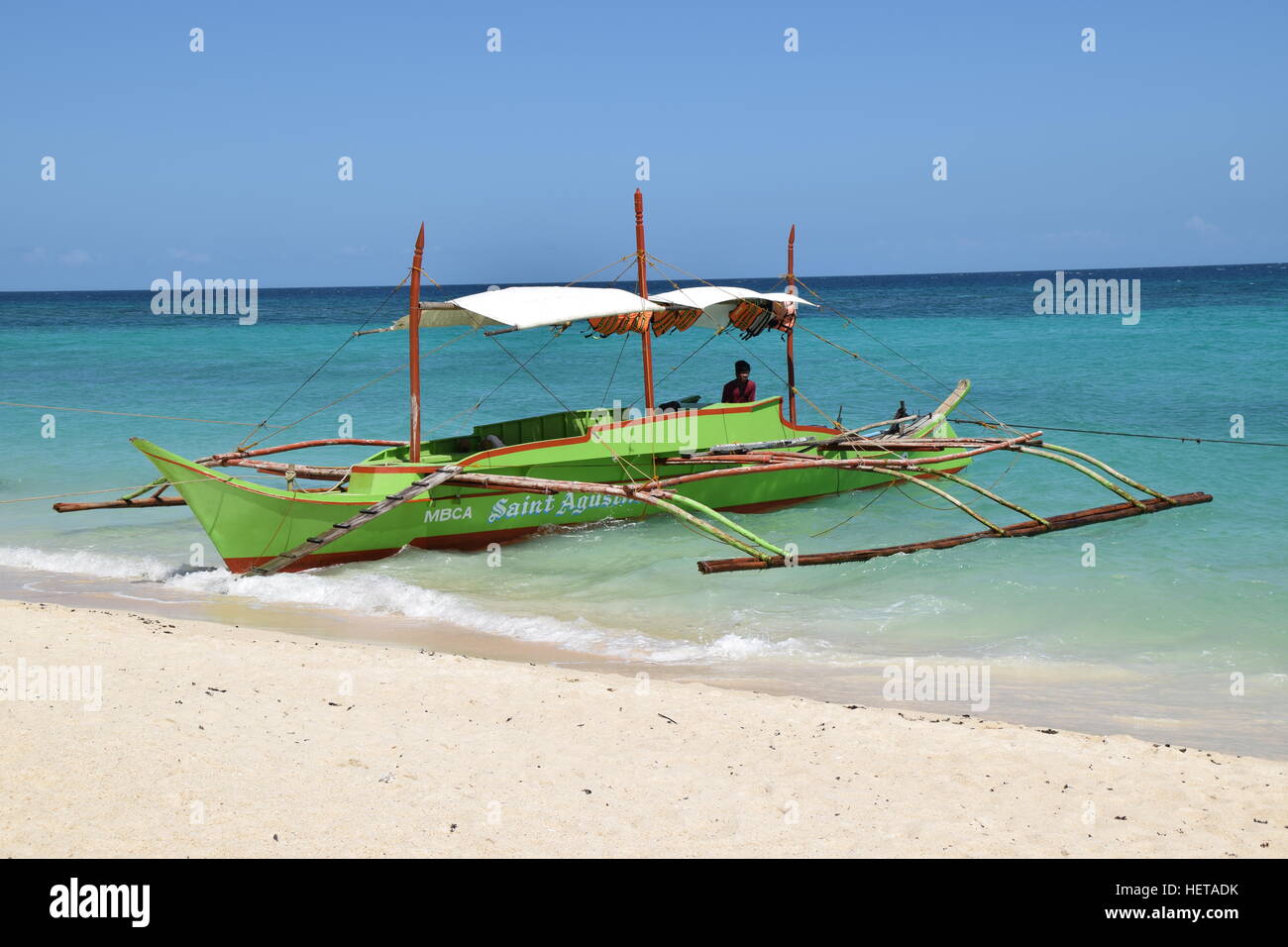 Traditional wooden boat at Puka beach on Boracay in the Philippines ...