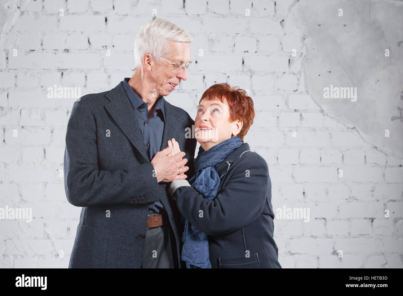 Happy smiling old couple standing cuddling together isolated on white ...