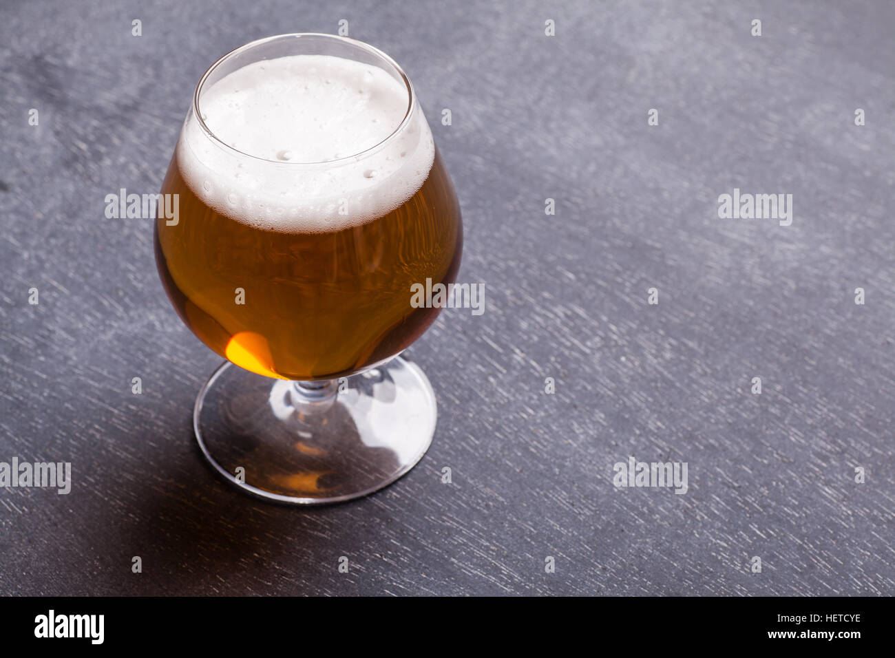 Small snifter glass with strong beer on a classic blackboard Stock ...