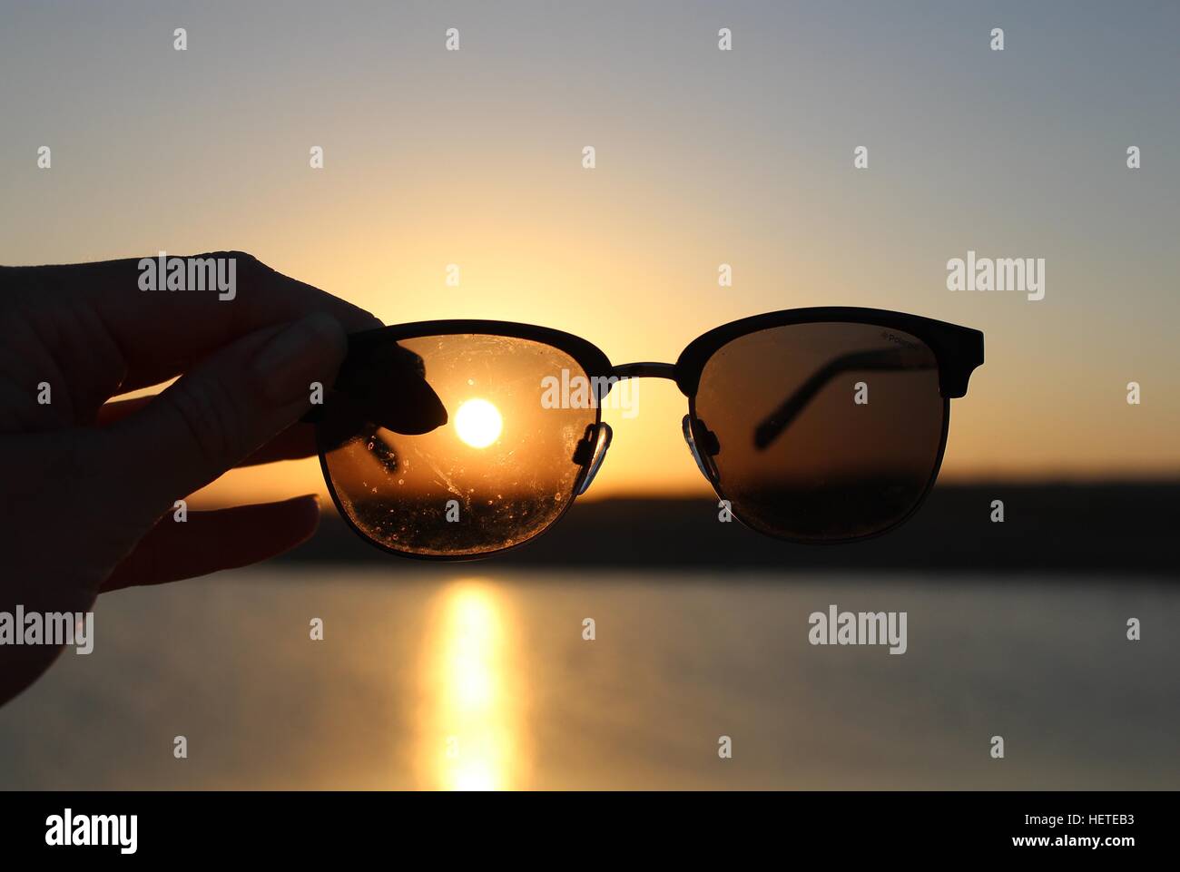 the sunsetting and the sun shinning through an sunglass lense also the ...