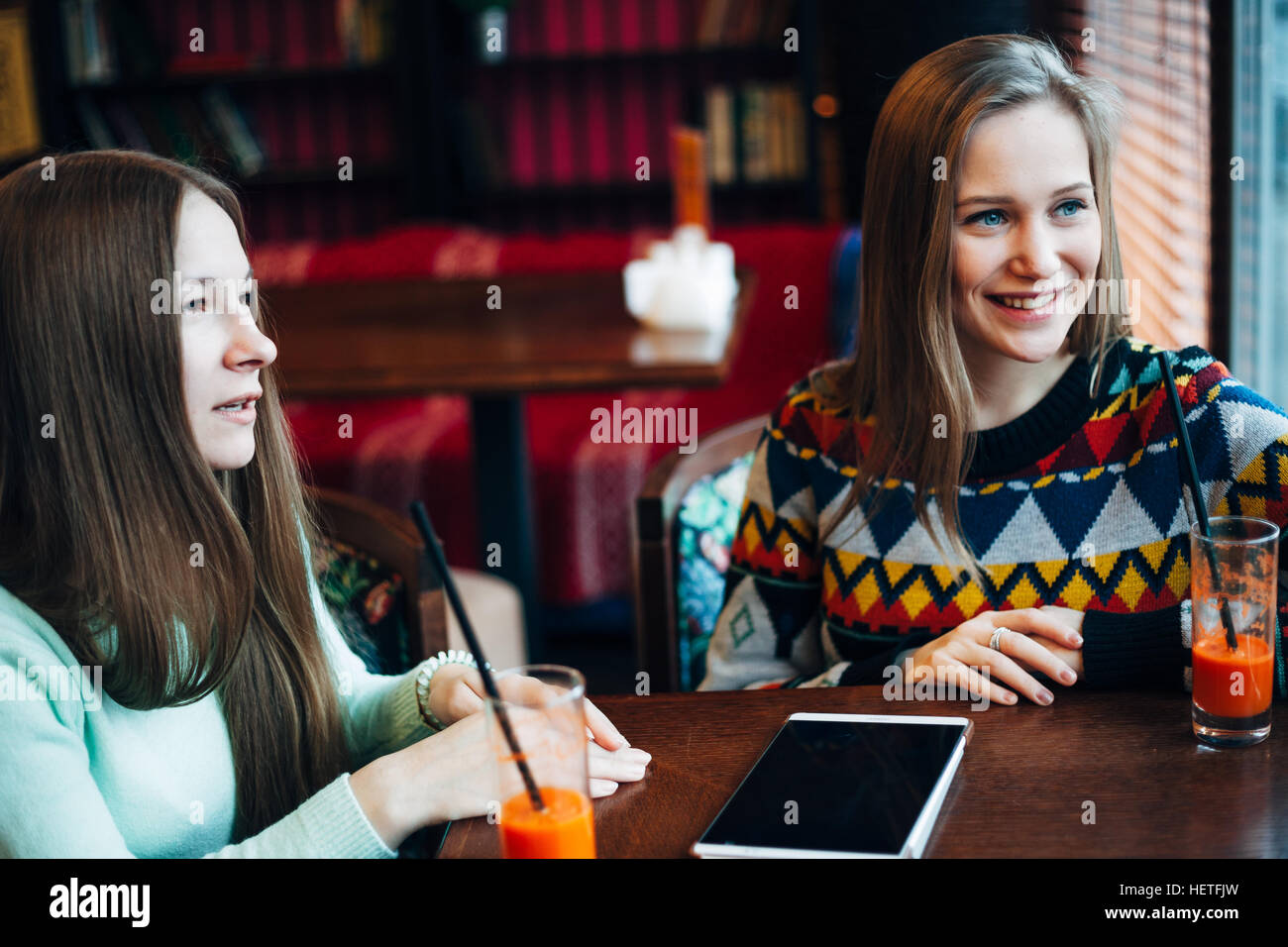 Girl friends communicate in a cafe Stock Photo - Alamy