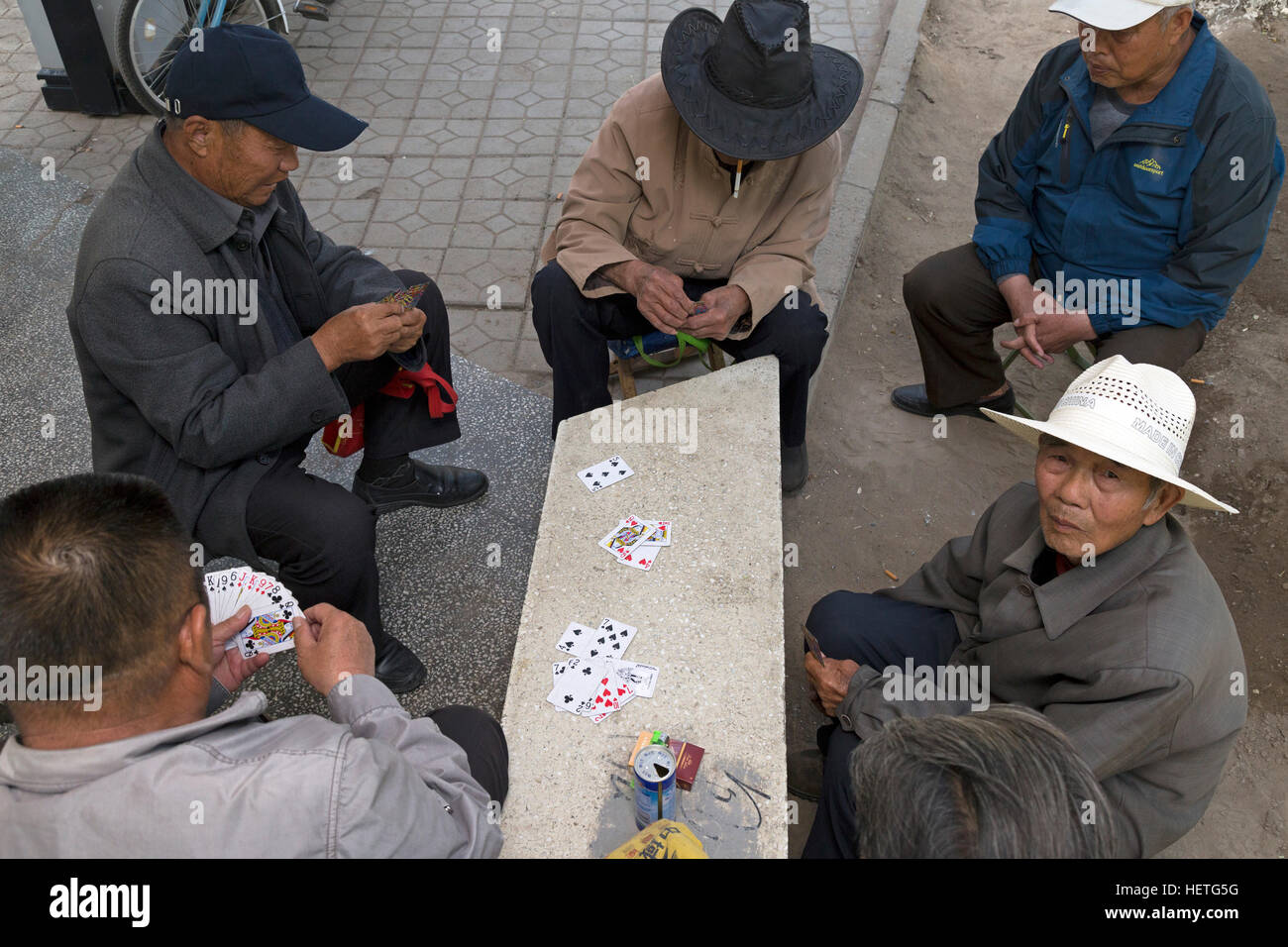 Chinese man with straw hat playing cards, Yinchuan, Ningxia, China ...
