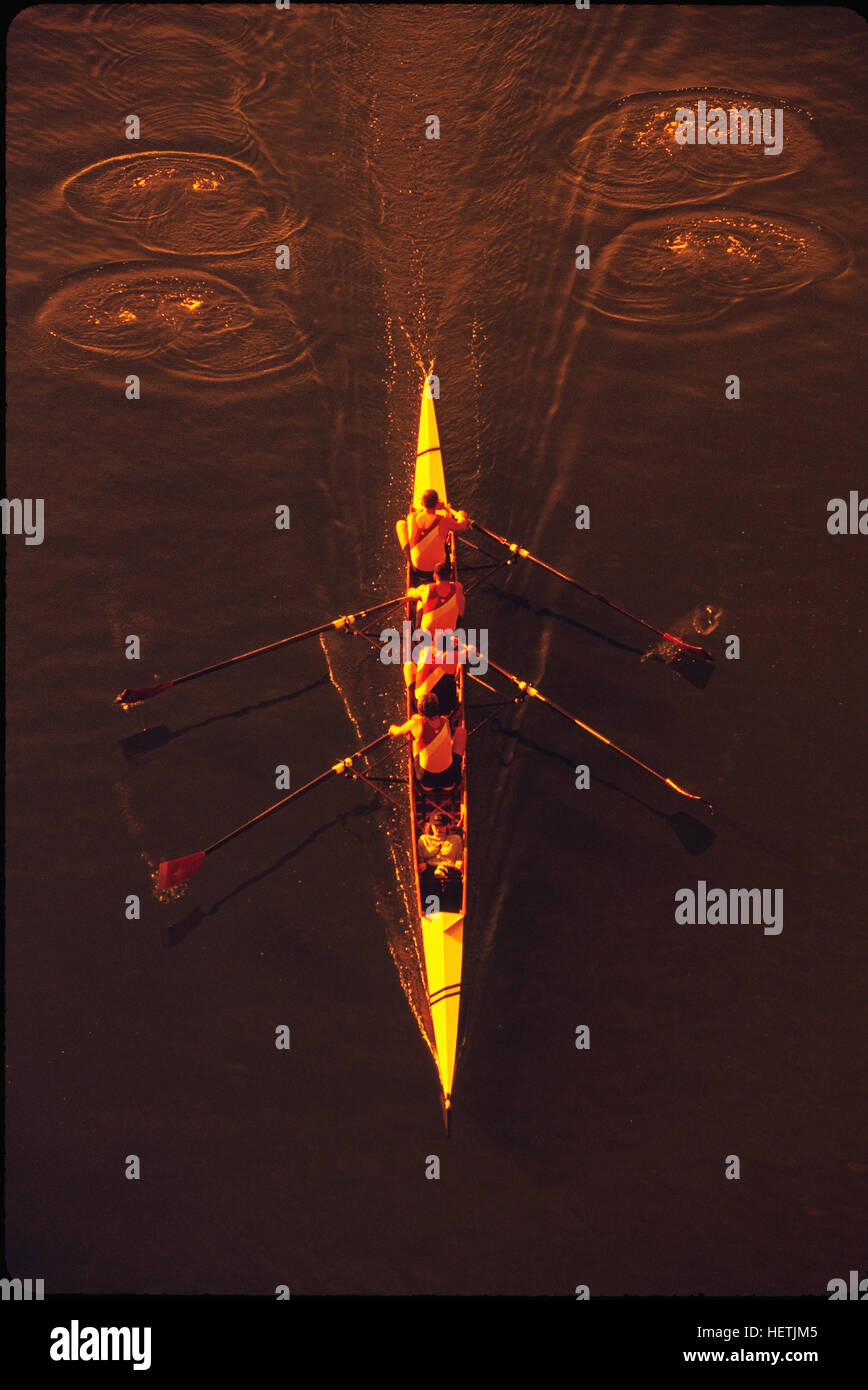 An aerial view of a rowing team practicing on a river in the late ...