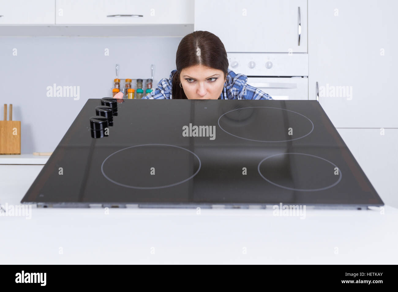 Woman installing kitchen hob Stock Photo - Alamy