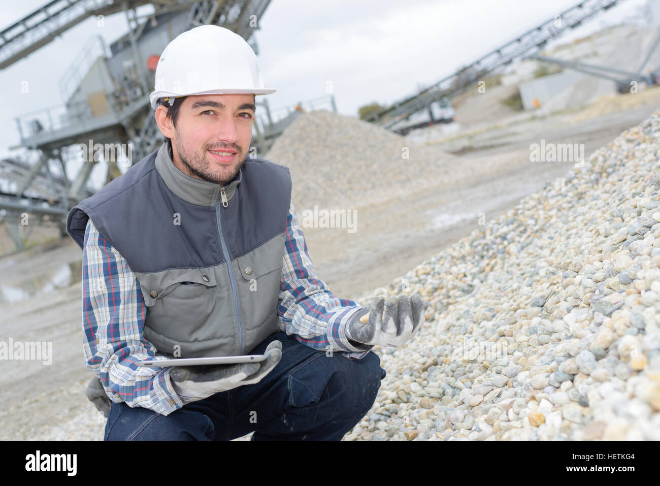 Portrait of worker checking stone in quarry Stock Photo - Alamy