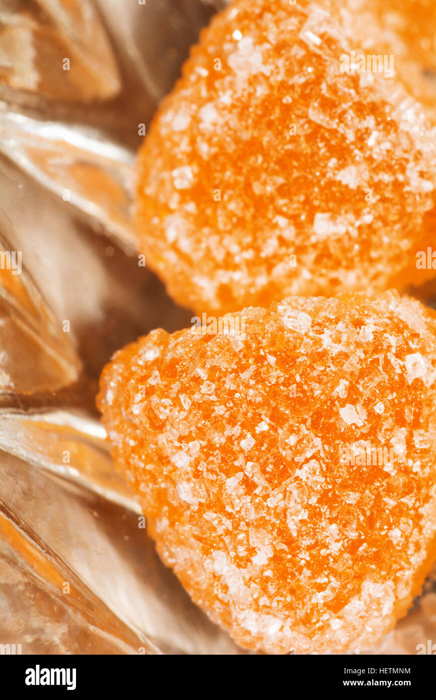 Tangerine candies in a crystal bowl Stock Photo - Alamy