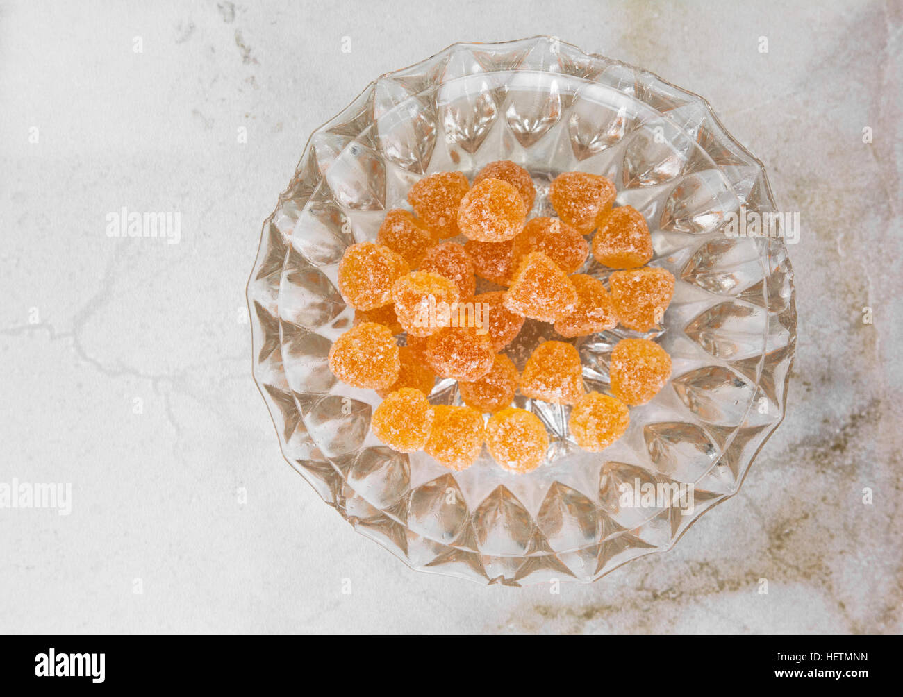 Tangerine candies in a crystal bowl Stock Photo - Alamy