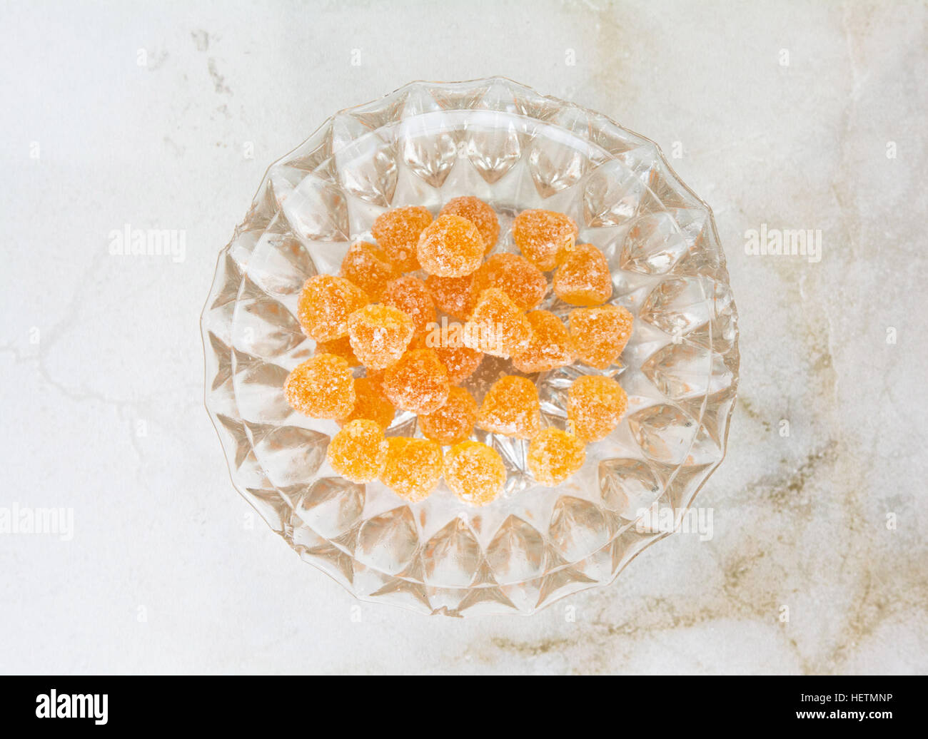 Tangerine candies in a crystal bowl Stock Photo - Alamy