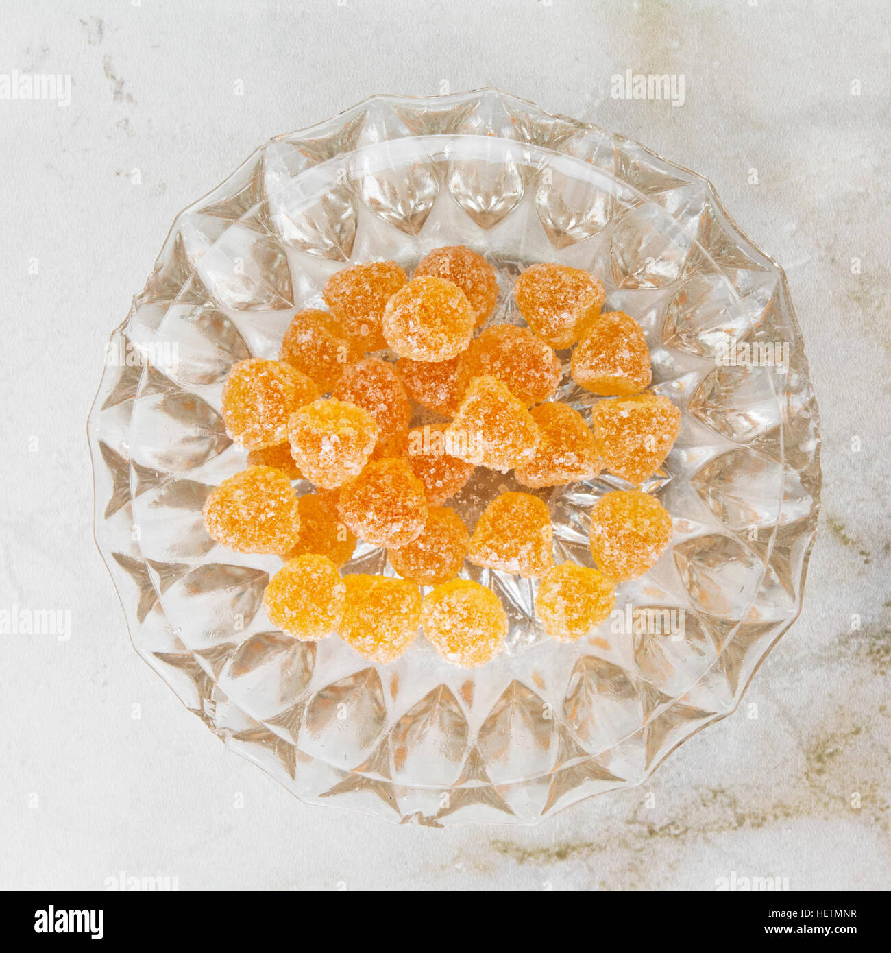 Tangerine candies in a crystal bowl Stock Photo - Alamy