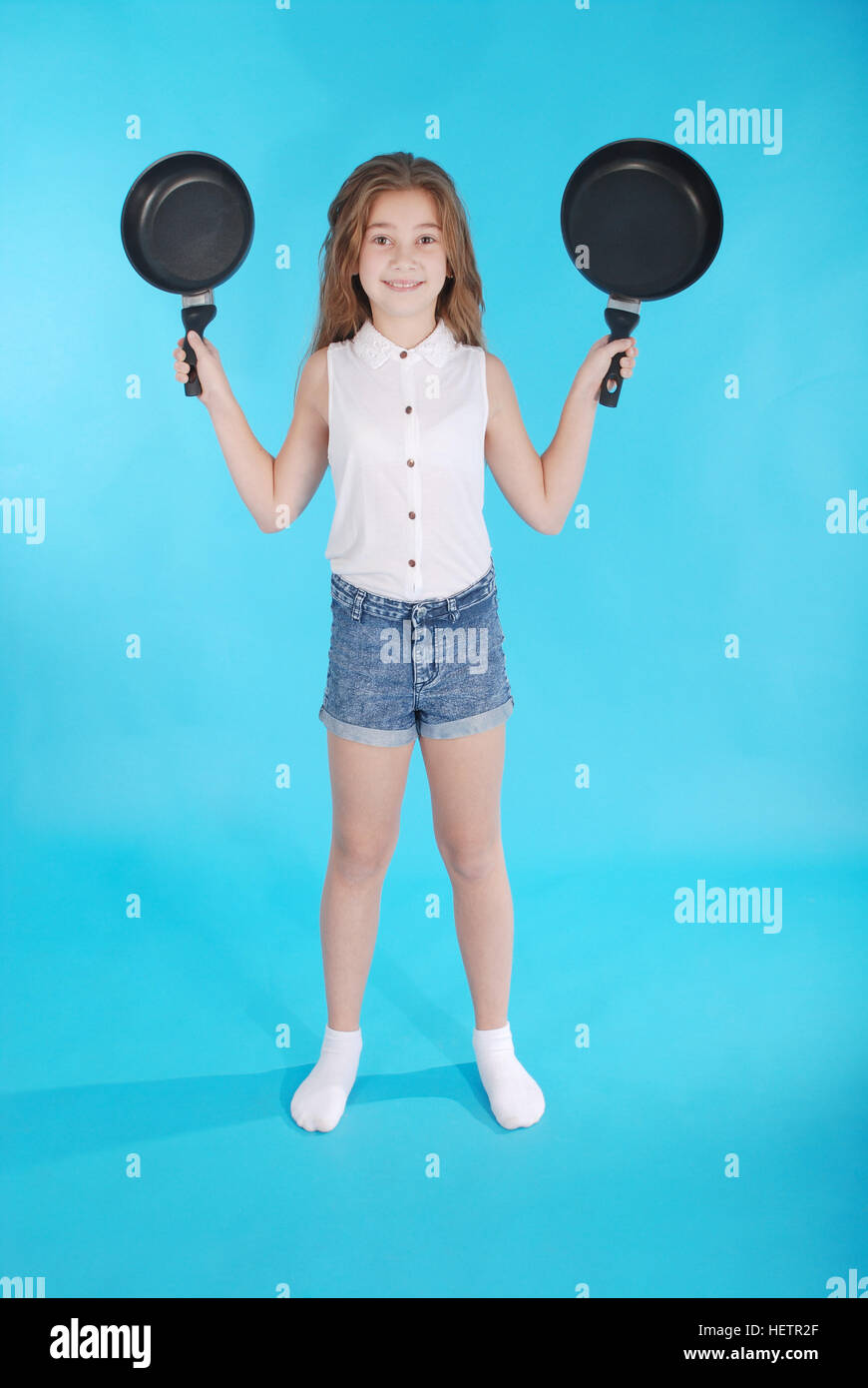Young lady holding frying pan hi-res stock photography and images - Alamy
