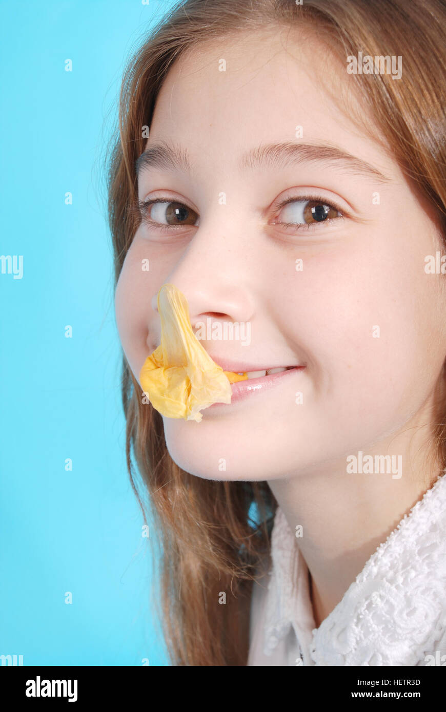 Young girl playing with chewing gum isolated on blue Stock Photo - Alamy