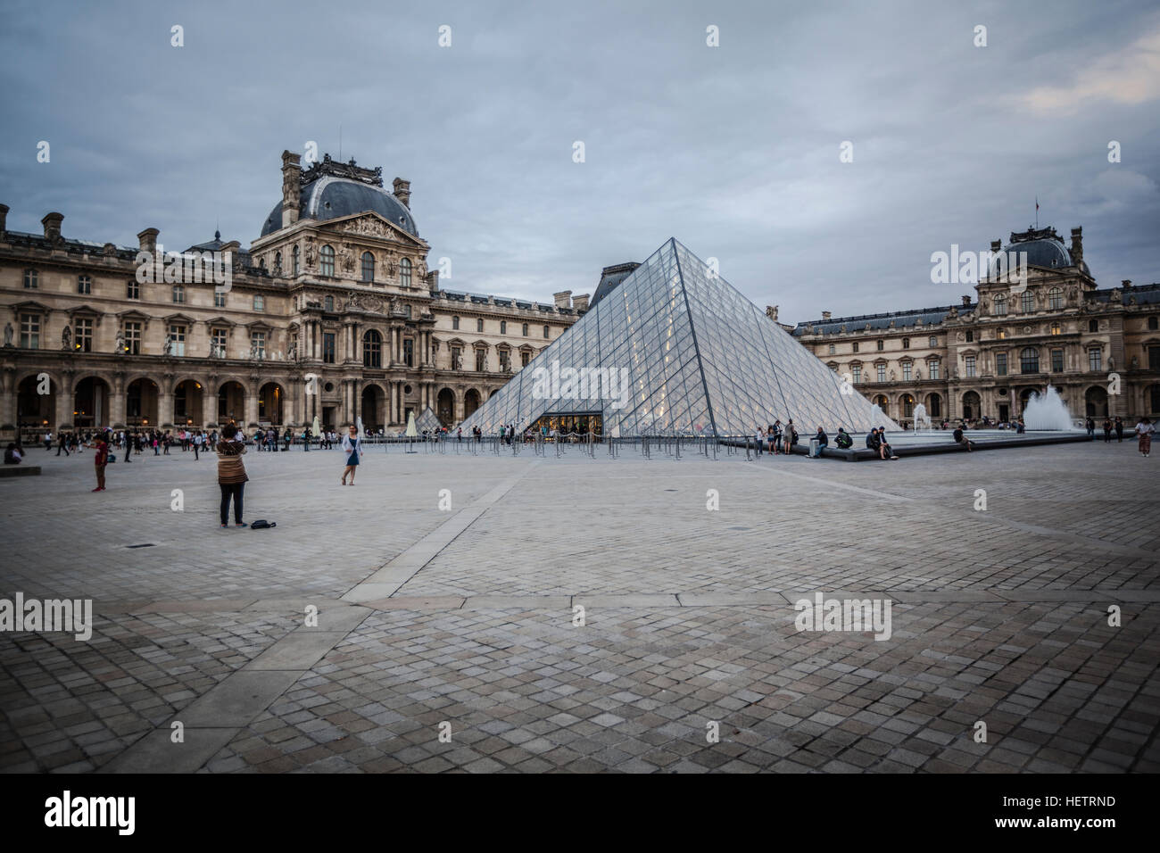 Louvre museum at dusk in Paris. This is one of the most popular tourist ...