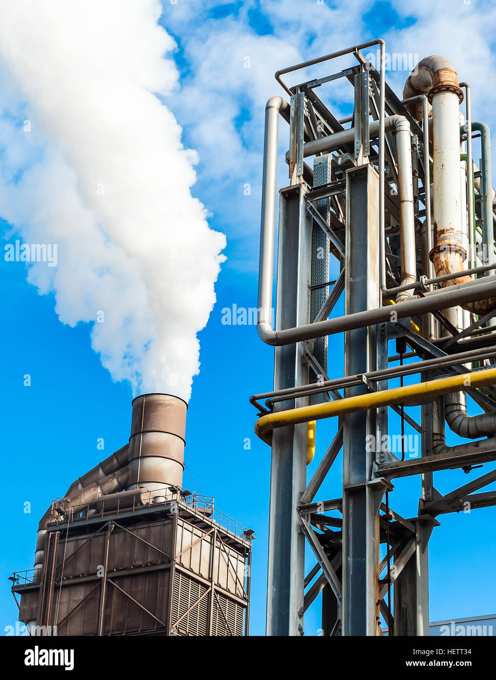 Pipes of chemical plant for factory, with smokestack on blue sky Stock ...