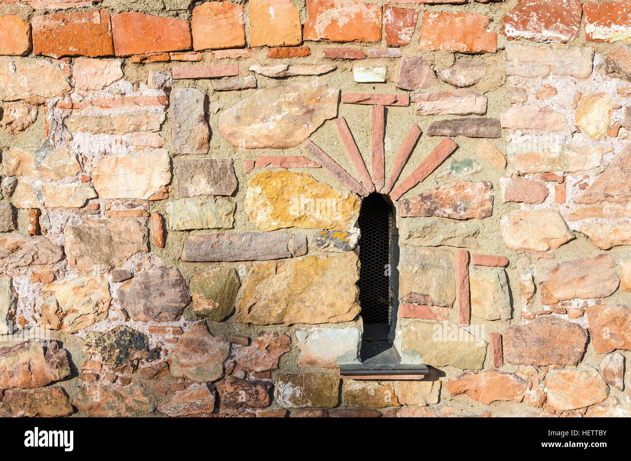 Sunlit stonework texture with narrow window of a castle or old ...