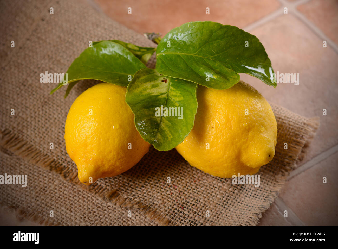 two yellow lemons on the table Stock Photo - Alamy