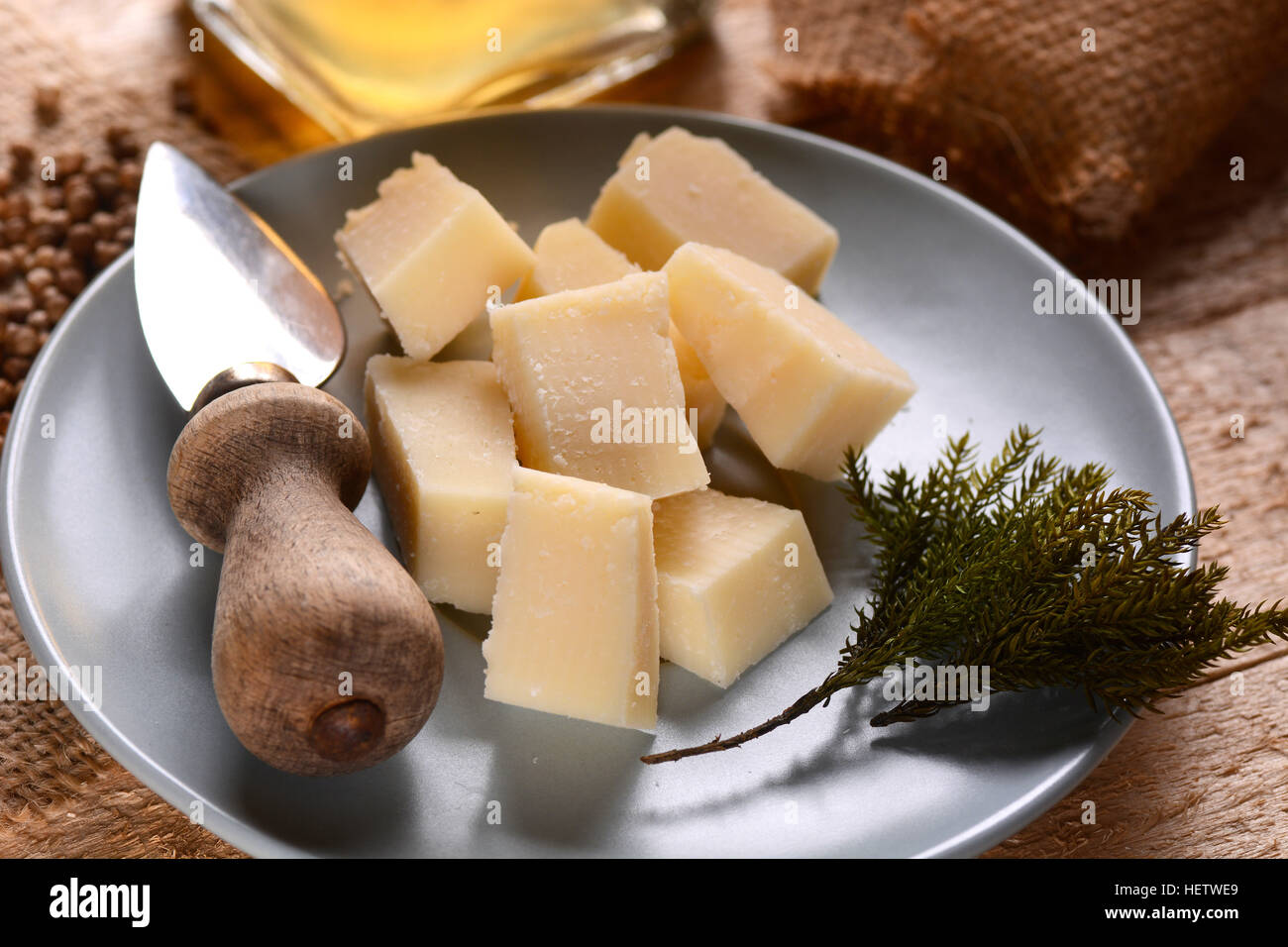 Parmesan cheese cubes with boxcutter Stock Photo - Alamy