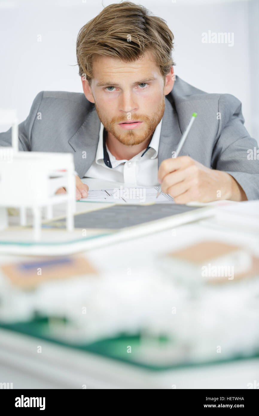 Architect making notes beside model building Stock Photo - Alamy Architect making notes beside model building Stock Photo - Alamy