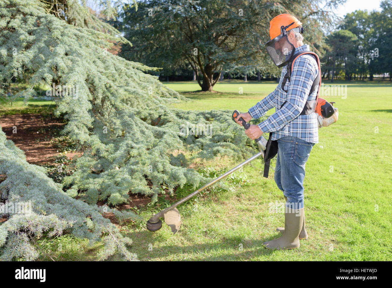 worker using a portable mower Stock Photo - Alamy