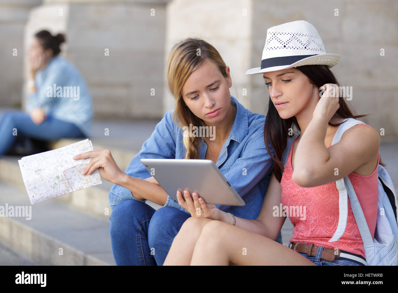 lost and confused girl friends looking for directions on map Stock ...
