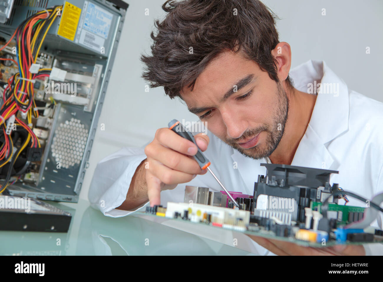Computer repairman using screwdriver Stock Photo - Alamy