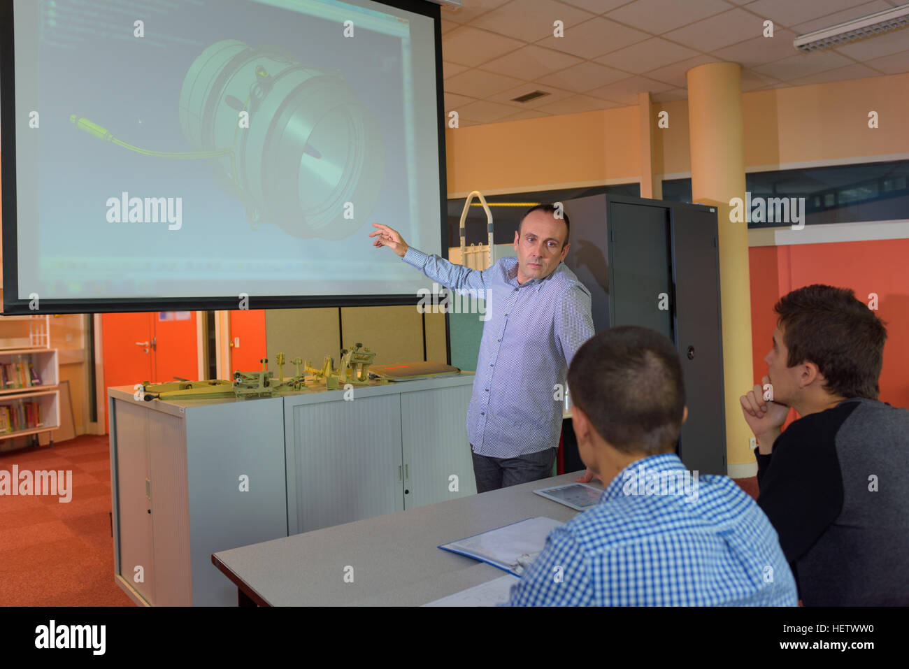 Man showing students projected image on screen Stock Photo - Alamy