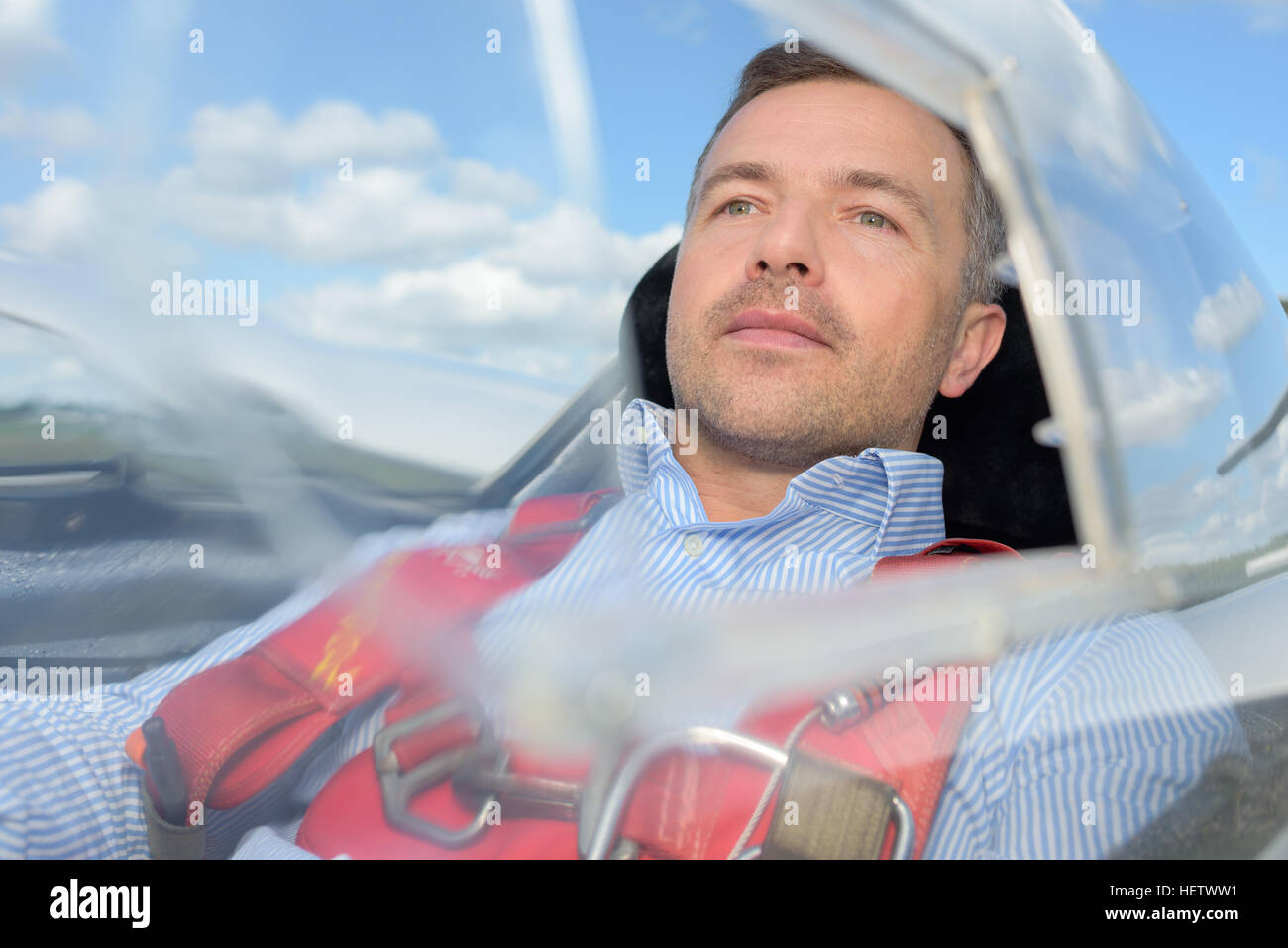 View of man in glider through glass roof Stock Photo - Alamy