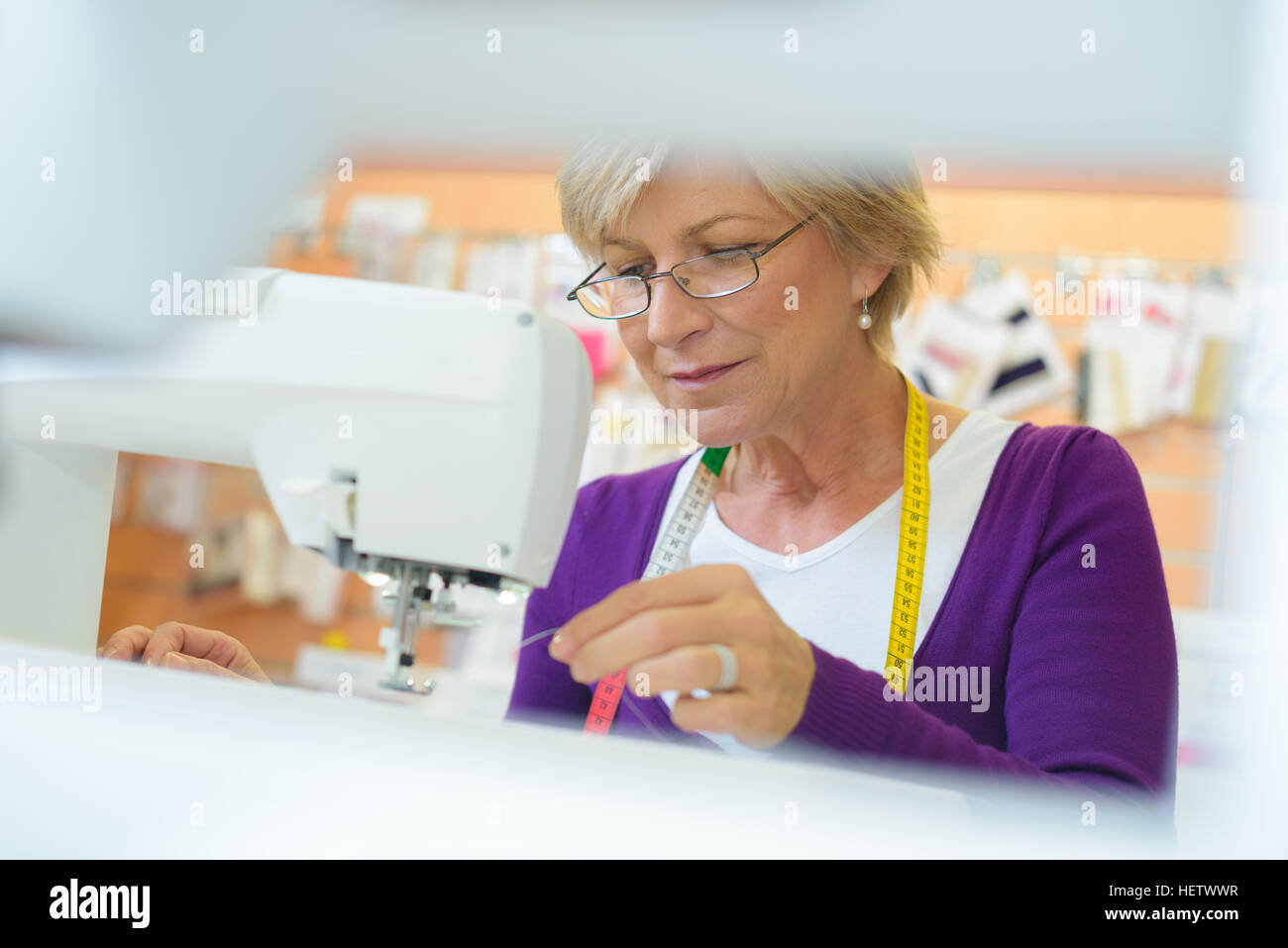 Elderly woman working sewing machine hi-res stock photography and ...