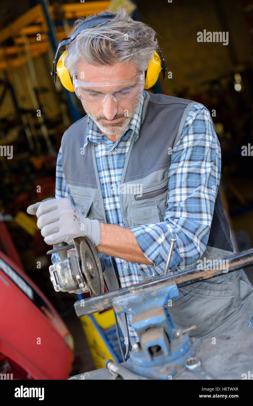 Man using angle grinder Stock Photo - Alamy