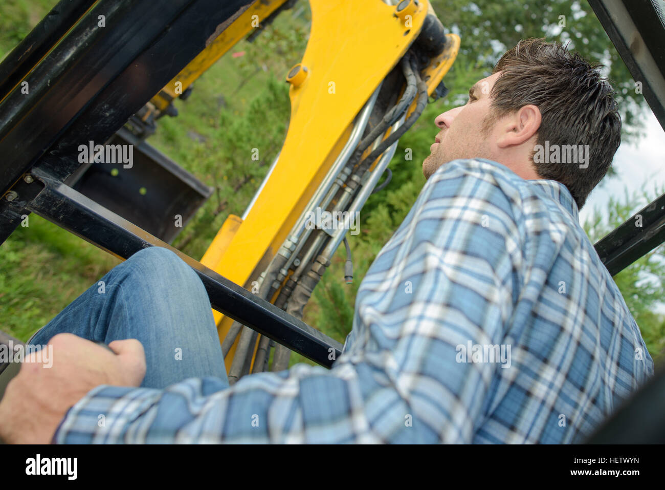 man operating digger Stock Photo - Alamy