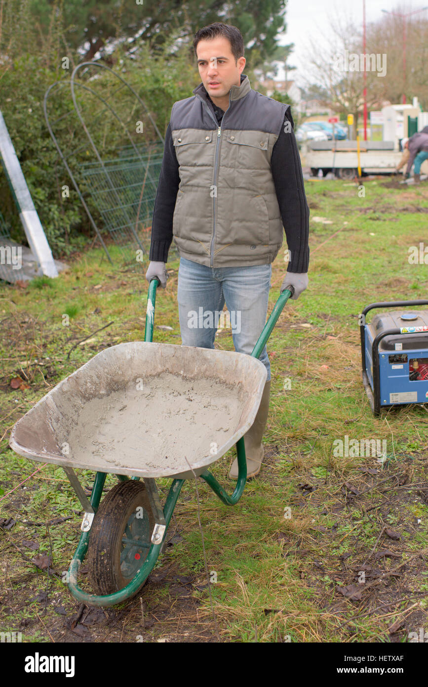 Man with barrow hi-res stock photography and images - Alamy