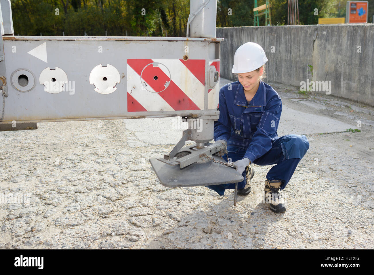 Lady positioning stabilising foot of crane Stock Photo - Alamy