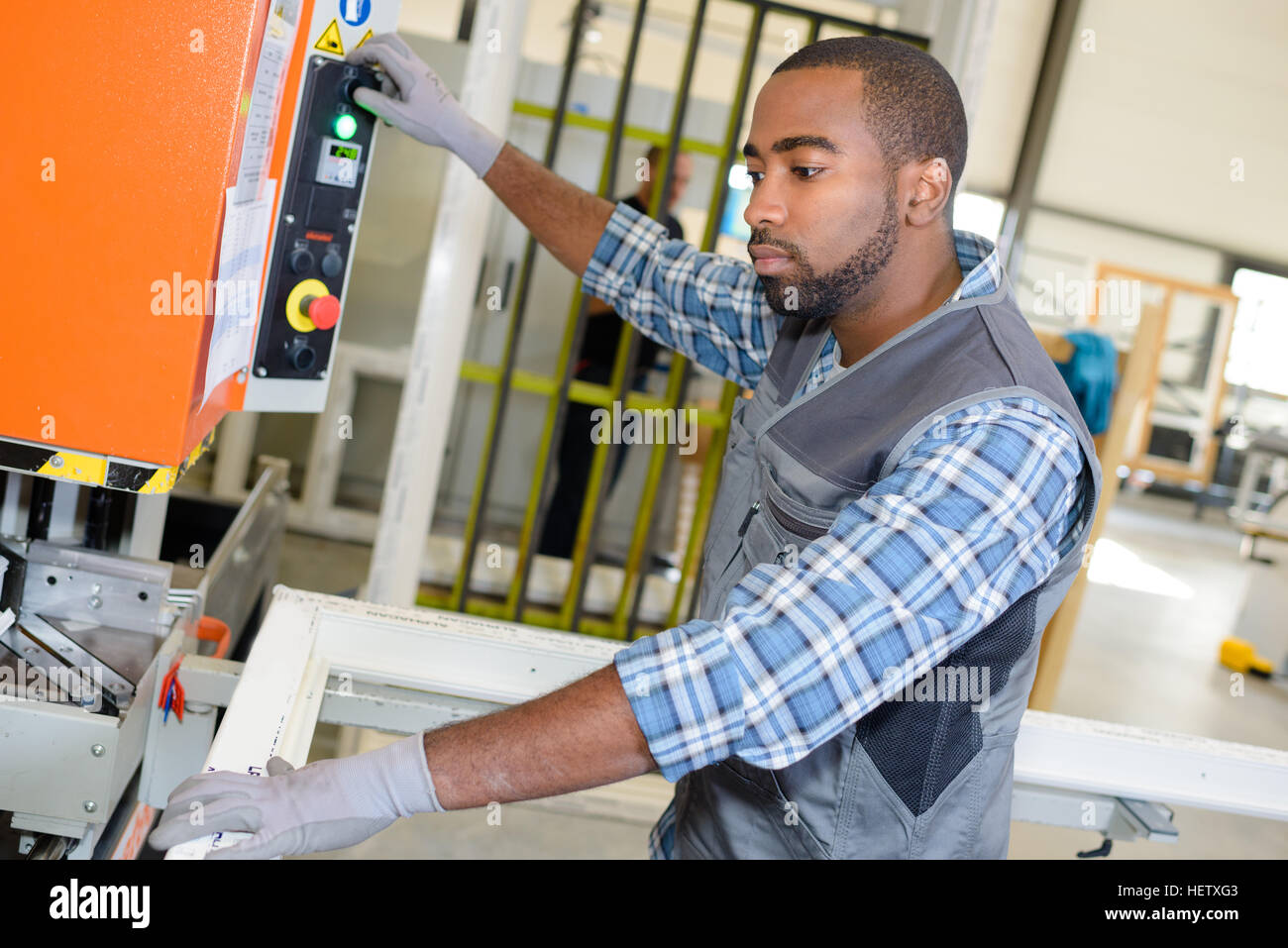 Worker activating machinery Stock Photo - Alamy