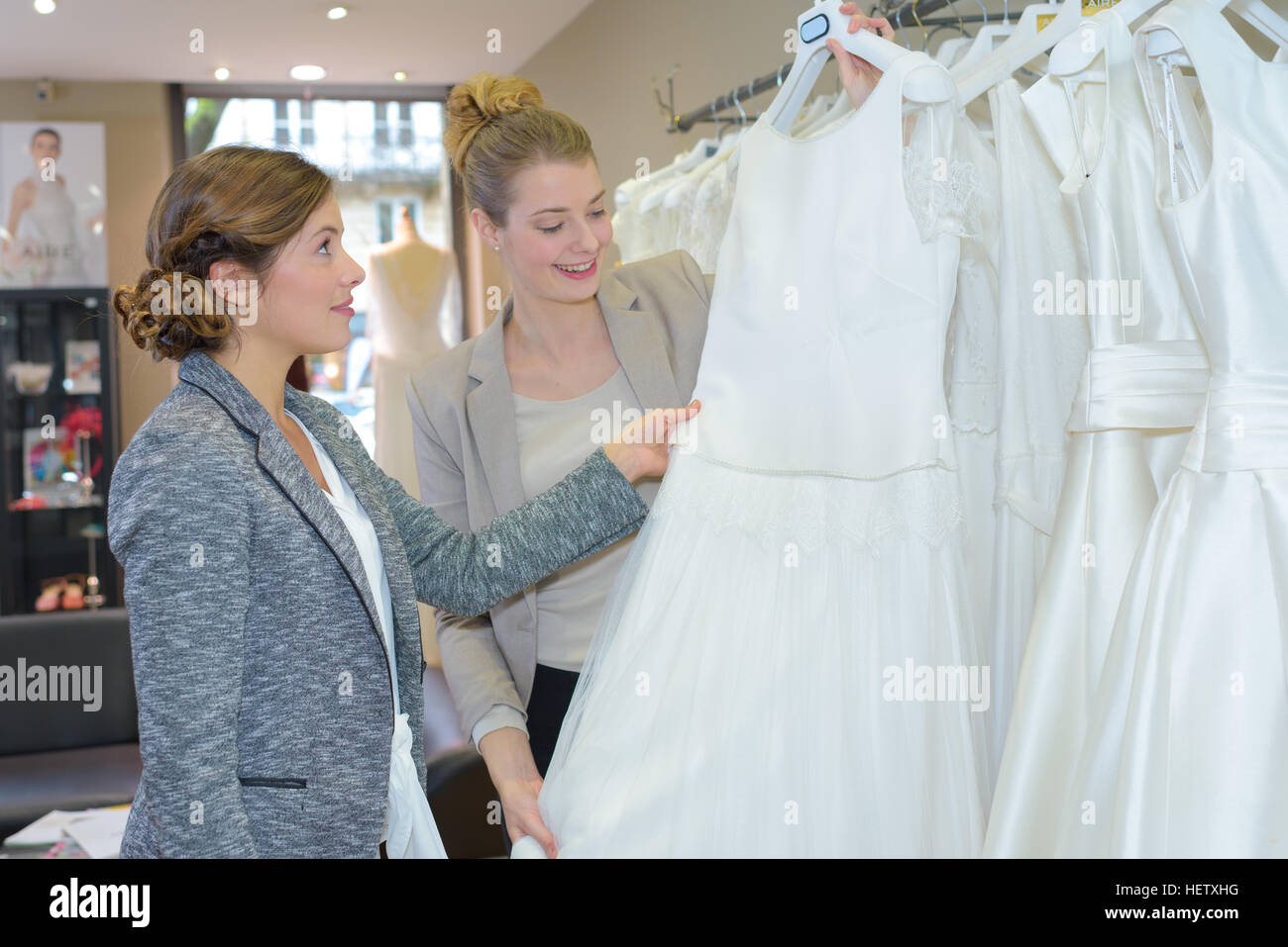 Woman viewing wedding dresses Stock Photo - Alamy