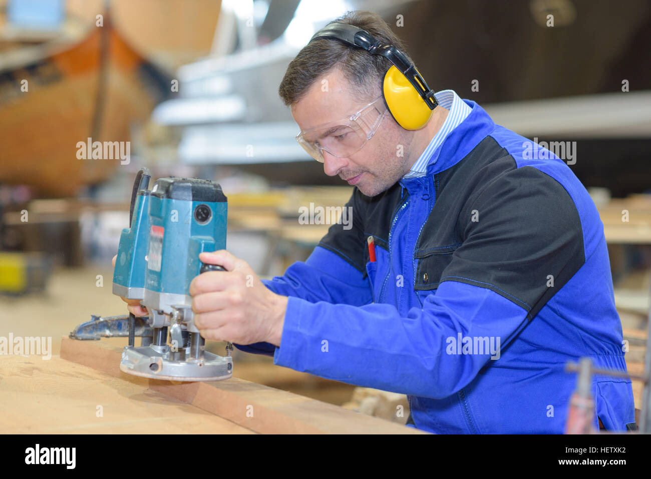 Worker using sander Stock Photo - Alamy