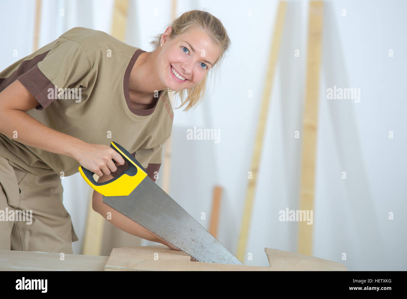 Woman using handsaw Stock Photo - Alamy
