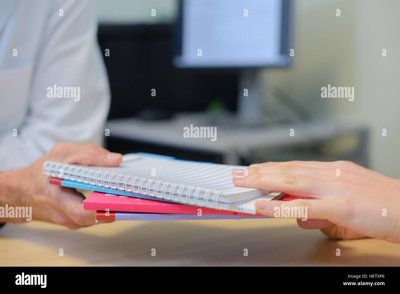 handing over notebooks Stock Photo - Alamy